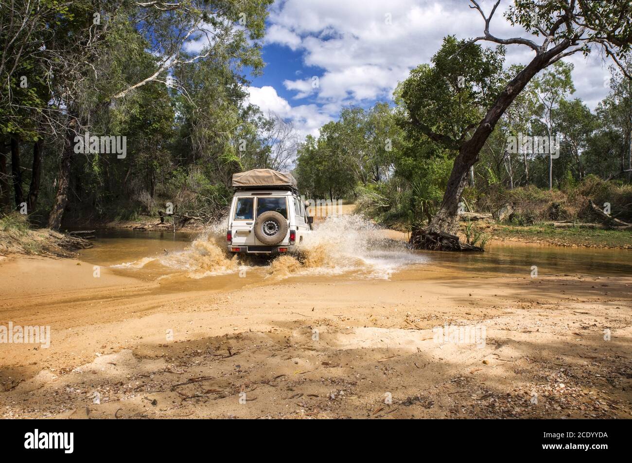 Western Australia – Flooded Outback gravel road with 4WD car crossing ...