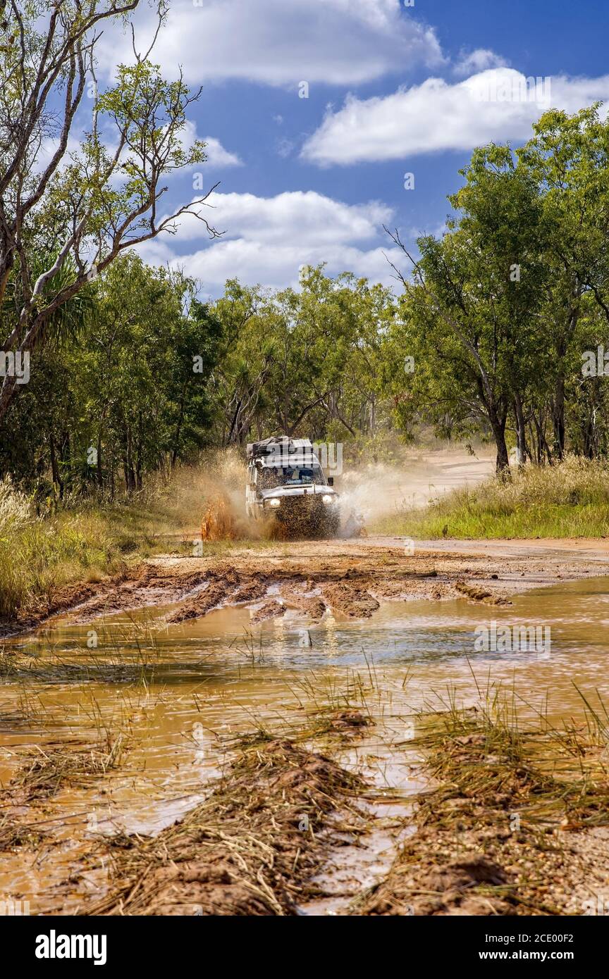Western Australia – Flooded Outback gravel road with 4WD car crossing ...