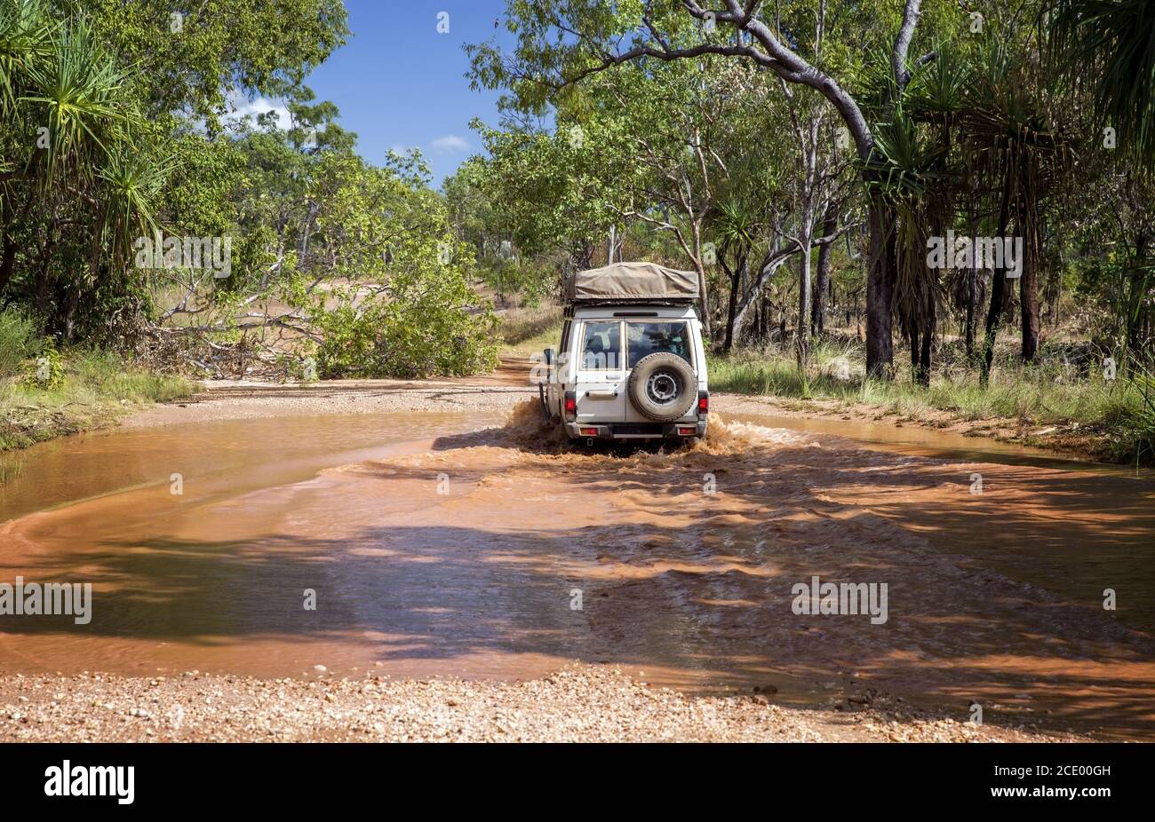 Western Australia Flooded Outback gravel road with 4WD car crossing the ...