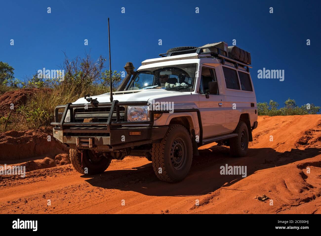Western Australia – Outback track with 4WD car downhill to the ocean at ...