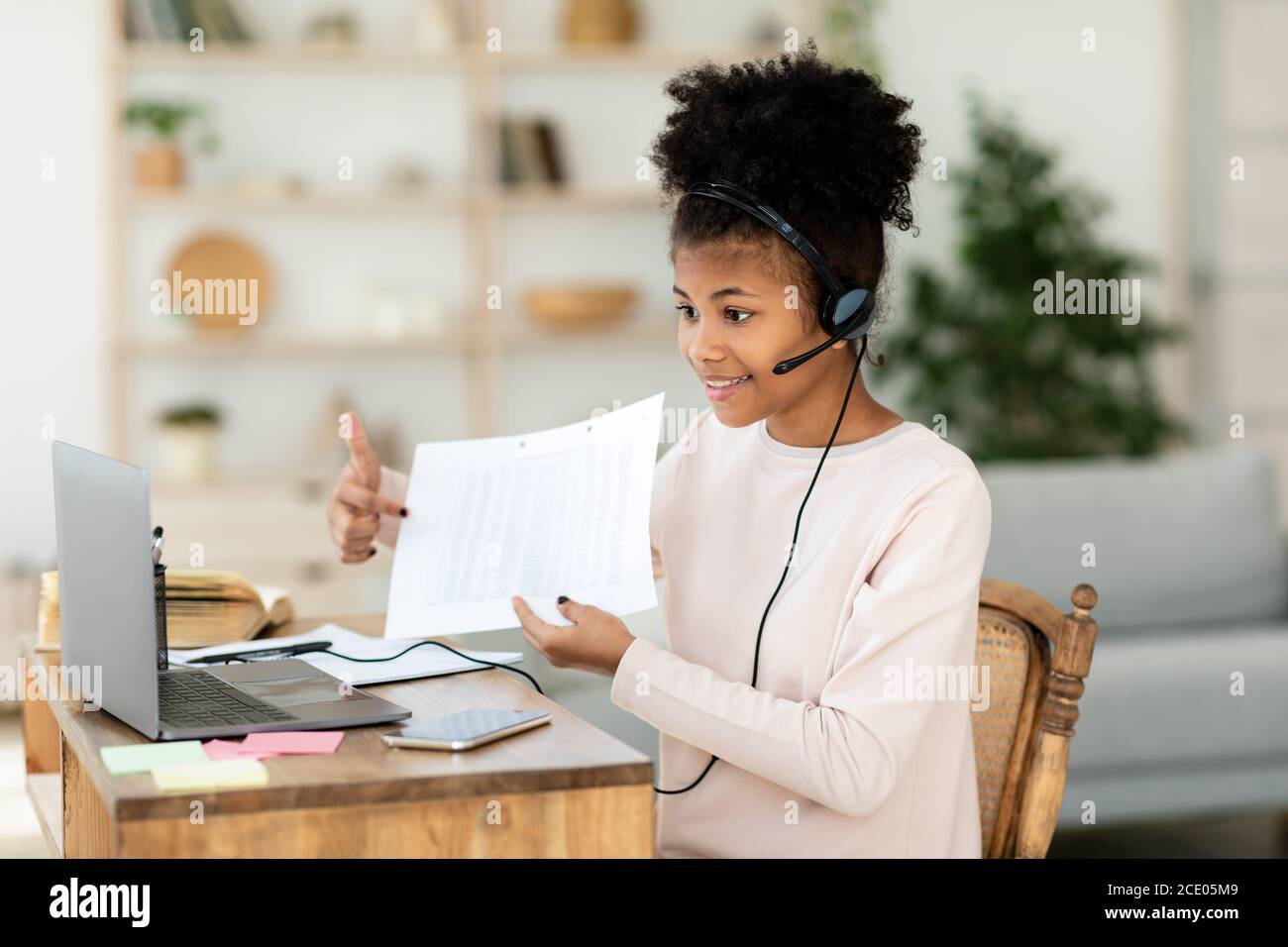 Girl At Laptop Showing Homework To Web Camera At Home Stock Photo - Alamy