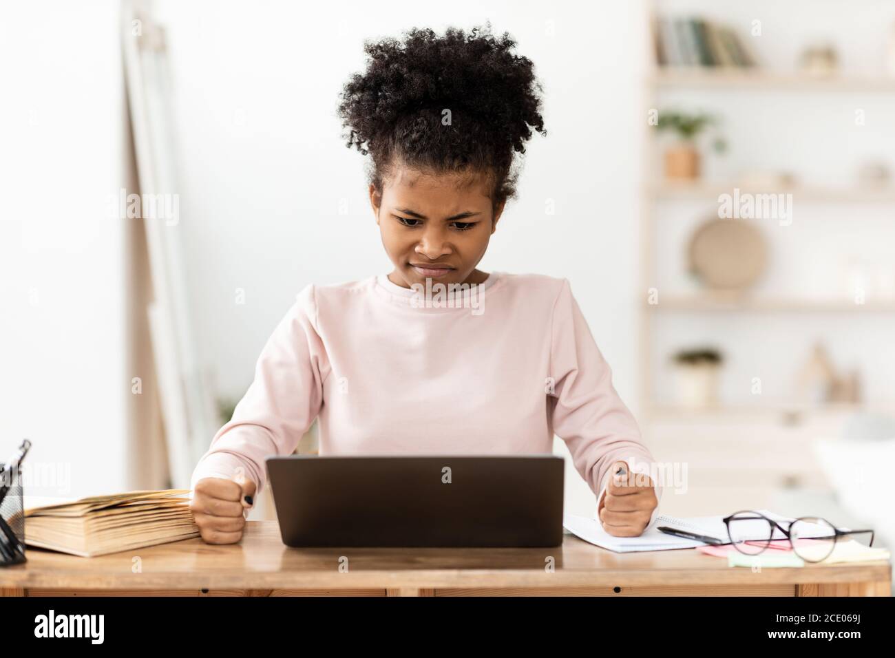 Angry Black Girl Looking At Laptop Screen Clenching Fists Indoors Stock ...