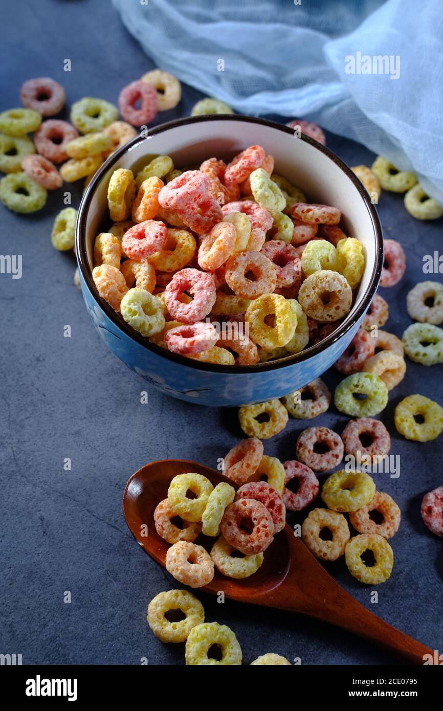 colorful ring corn flakes in a bowl on black background Stock Photo - Alamy