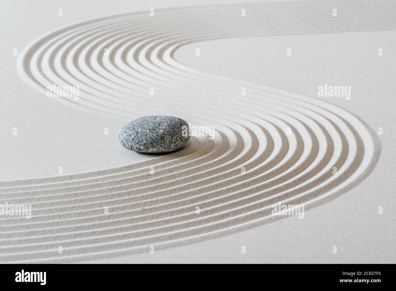 japanese garden with stone in textured sand Stock Photo - Alamy