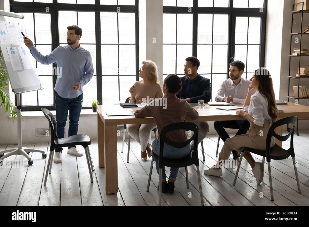 Skilled young sales trainer giving educational lecture to business ...