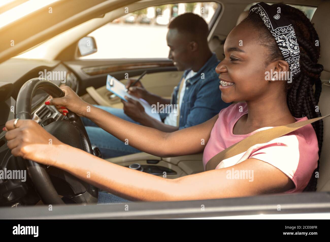 African girl taking driving test with professional instructor Stock ...