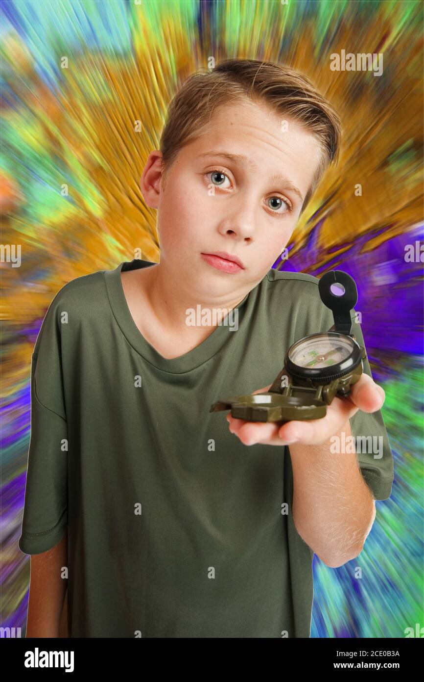 Boy with compass inquiring look colourful Stock Photo - Alamy