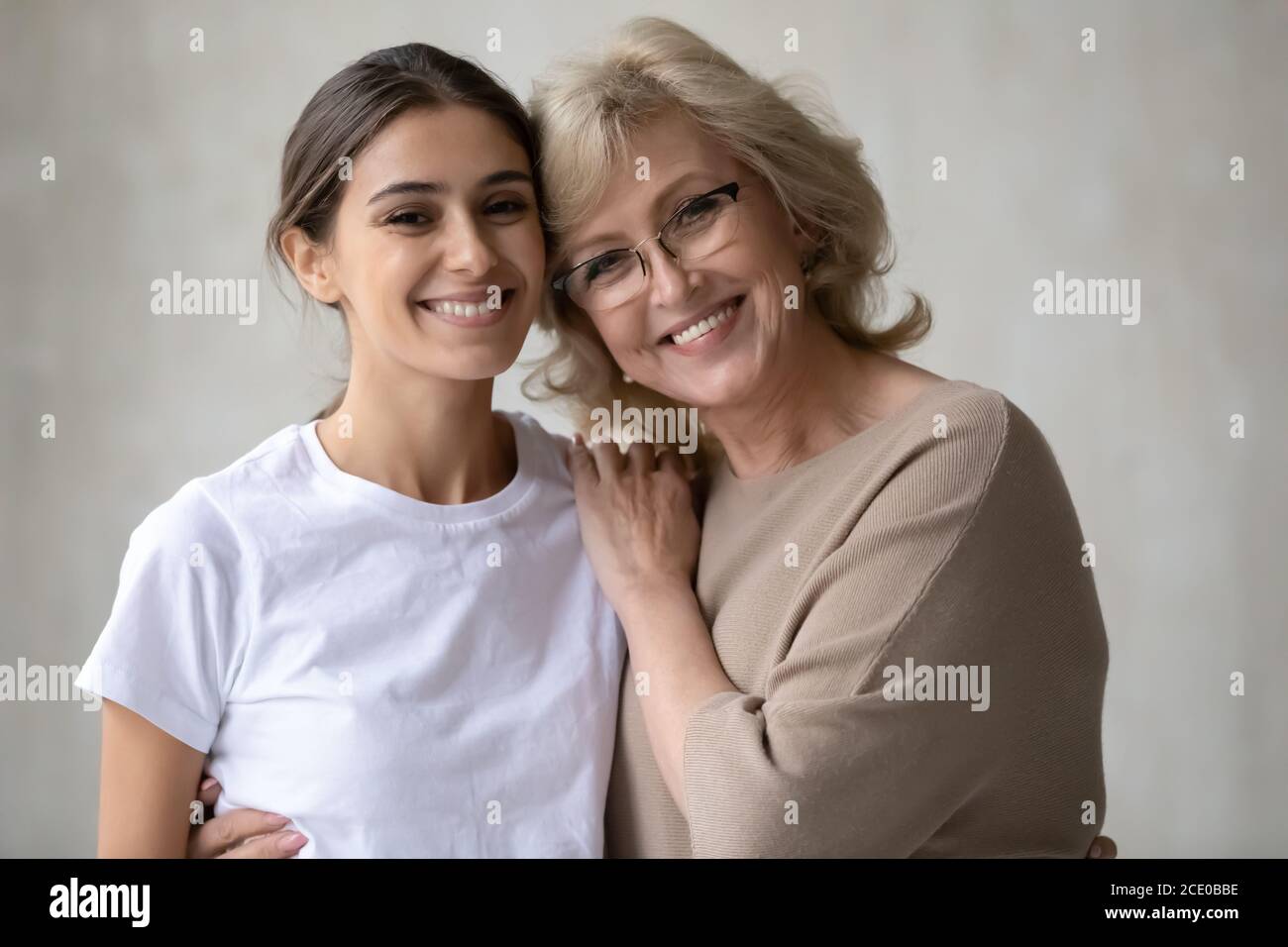 Portrait of smiling multiracial different female generations family ...