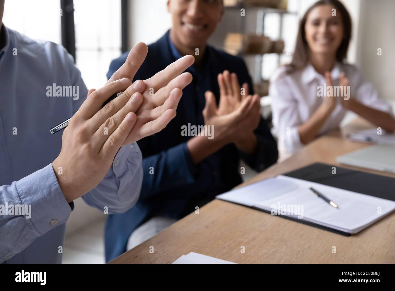 Close up happy diverse business people clapping hands Stock Photo - Alamy