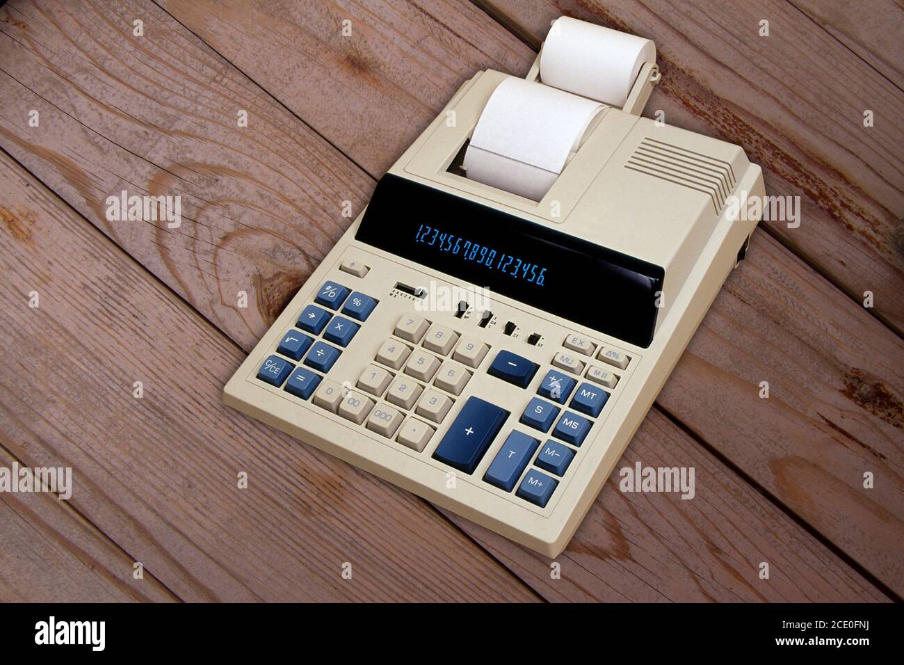 LED display electronic calculator on wooden background. Battery-powered ...