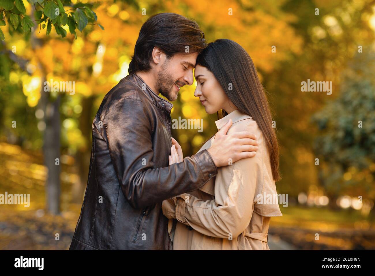 Couple in love hugging, touching each other with foreheads Stock Photo ...