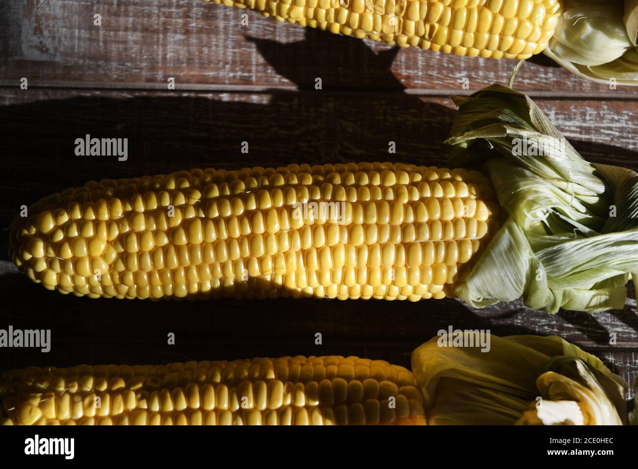 YELLOW CROP: Ripe fresh corn lays on a wooden canvas board in the ...