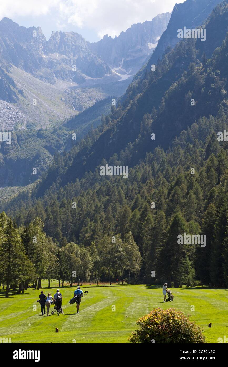Playing golf in summer time on Alps Stock Photo - Alamy