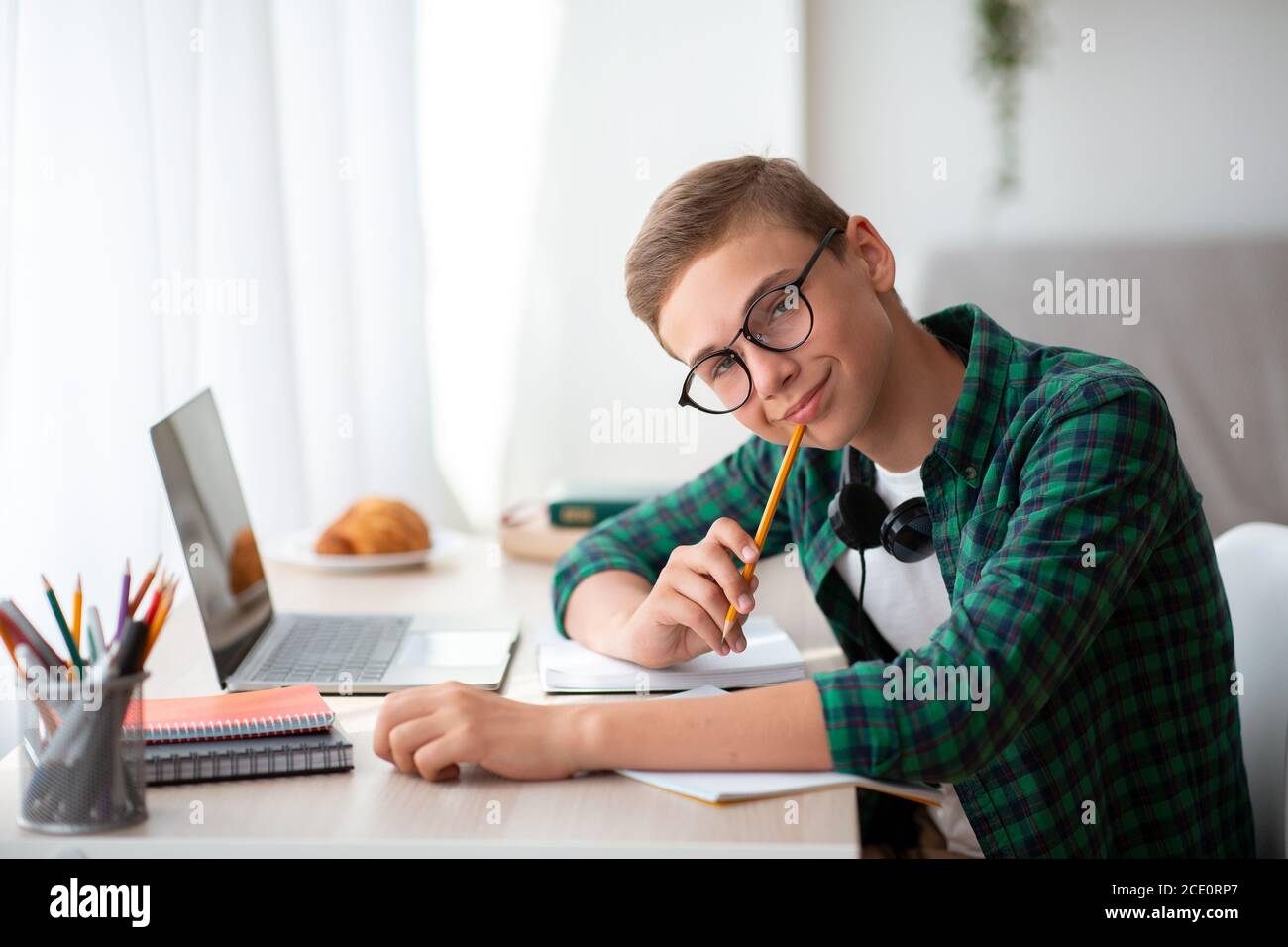 Smiling nerd guy enjoying his studying at home Stock Photo - Alamy