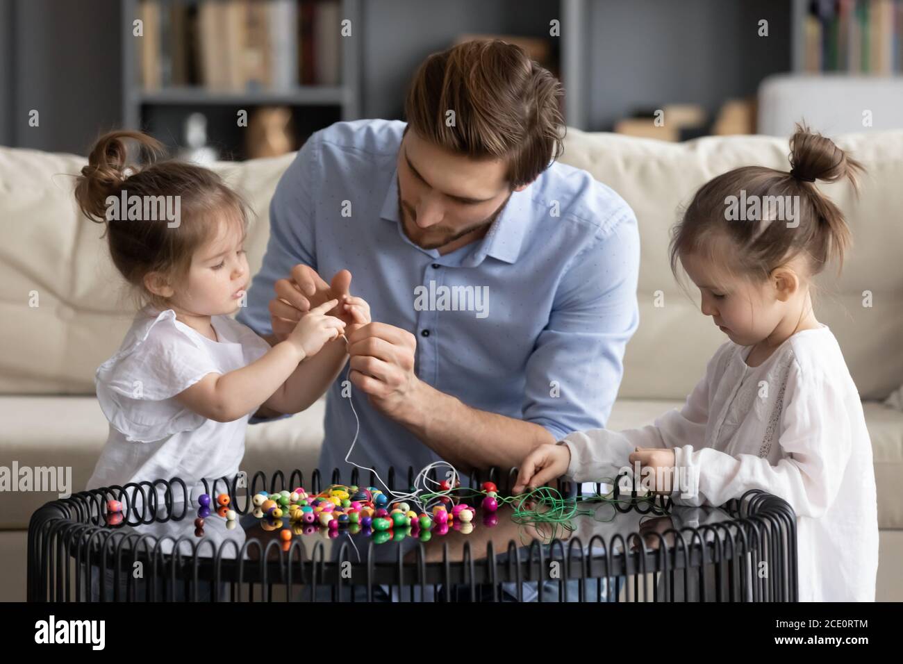 Happy parent involved in handmade activity with small kids girls Stock ...
