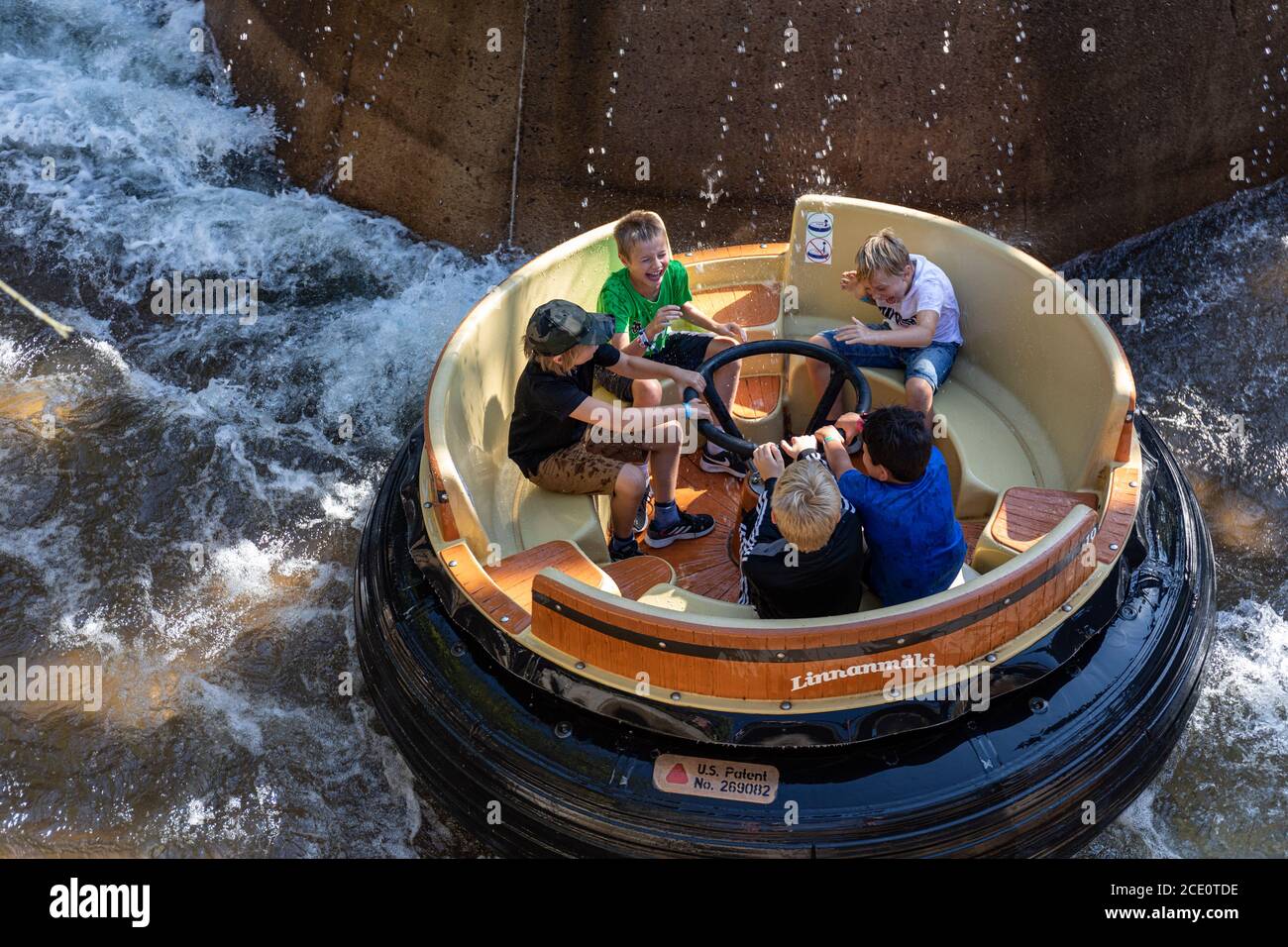 Young boys laughing on circular raft of Hurjakuru river rapids ride in ...
