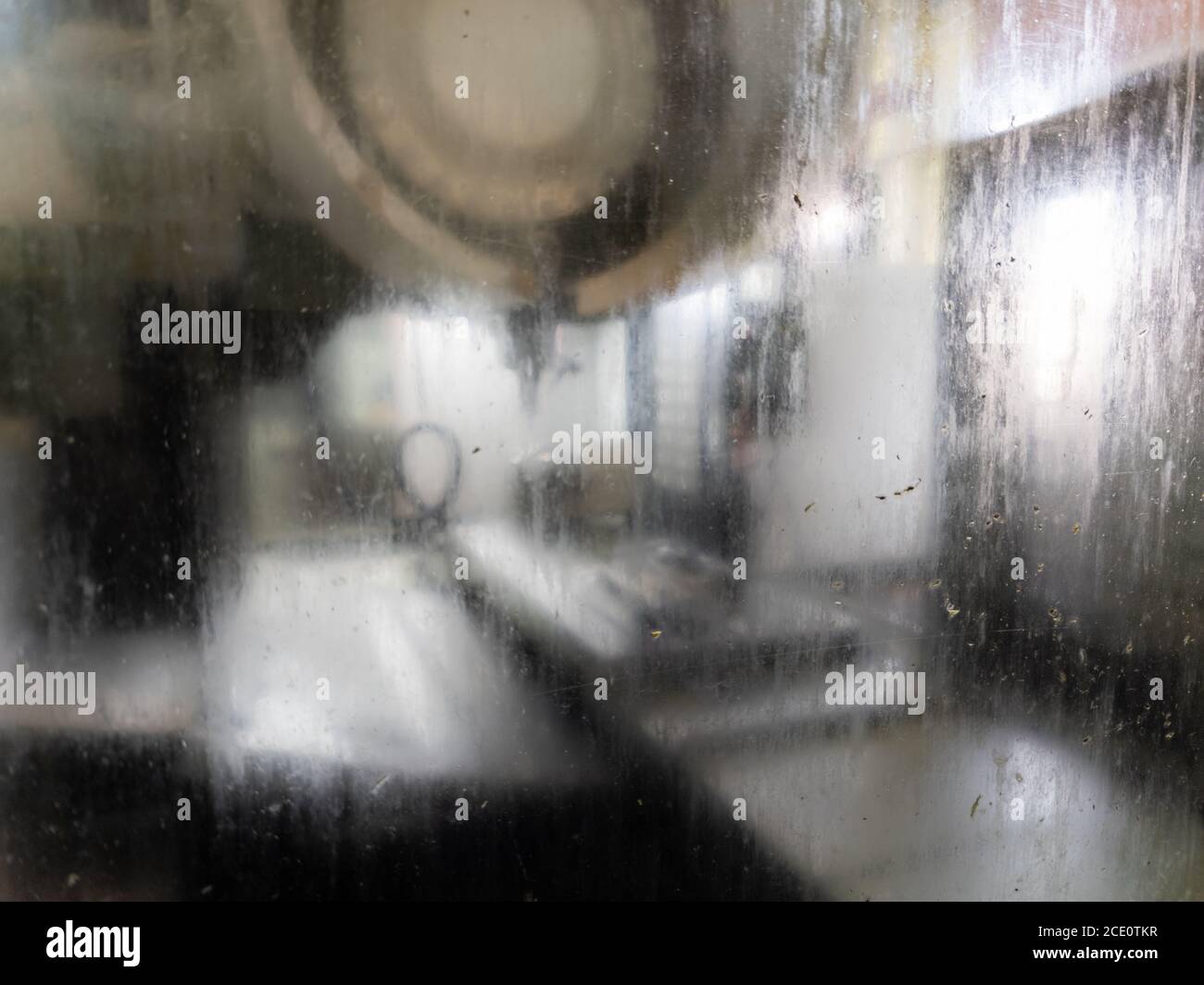 wet and dirty glass of cnc milling machine - close-up with selective ...
