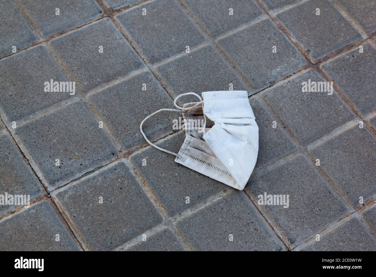 Stock photo of a used mask lying on the ground in the city. Masks ...