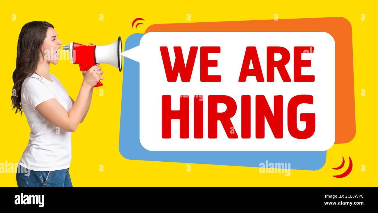 Side view of young girl shouting WE ARE HIRING announcement through ...