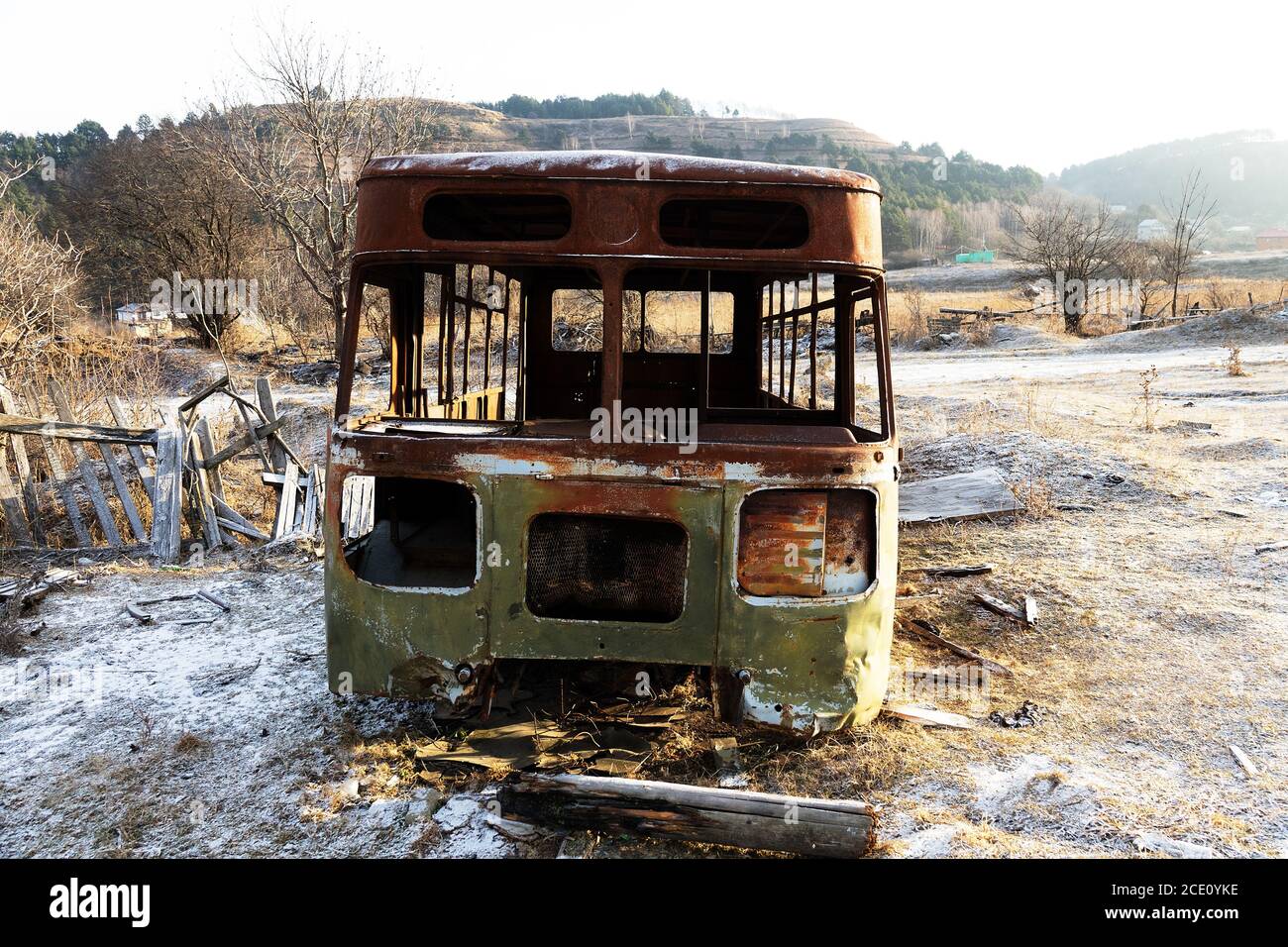 skeleton of abandoned old bus against winter hills Stock Photo - Alamy