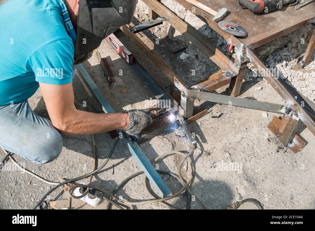 Welder welds metal structure. Construction worker at work. A working ...