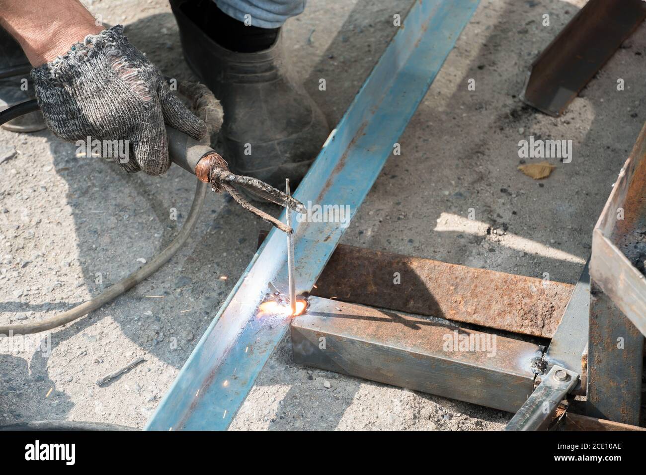 Welder welds metal structure. Construction worker at work. A working ...