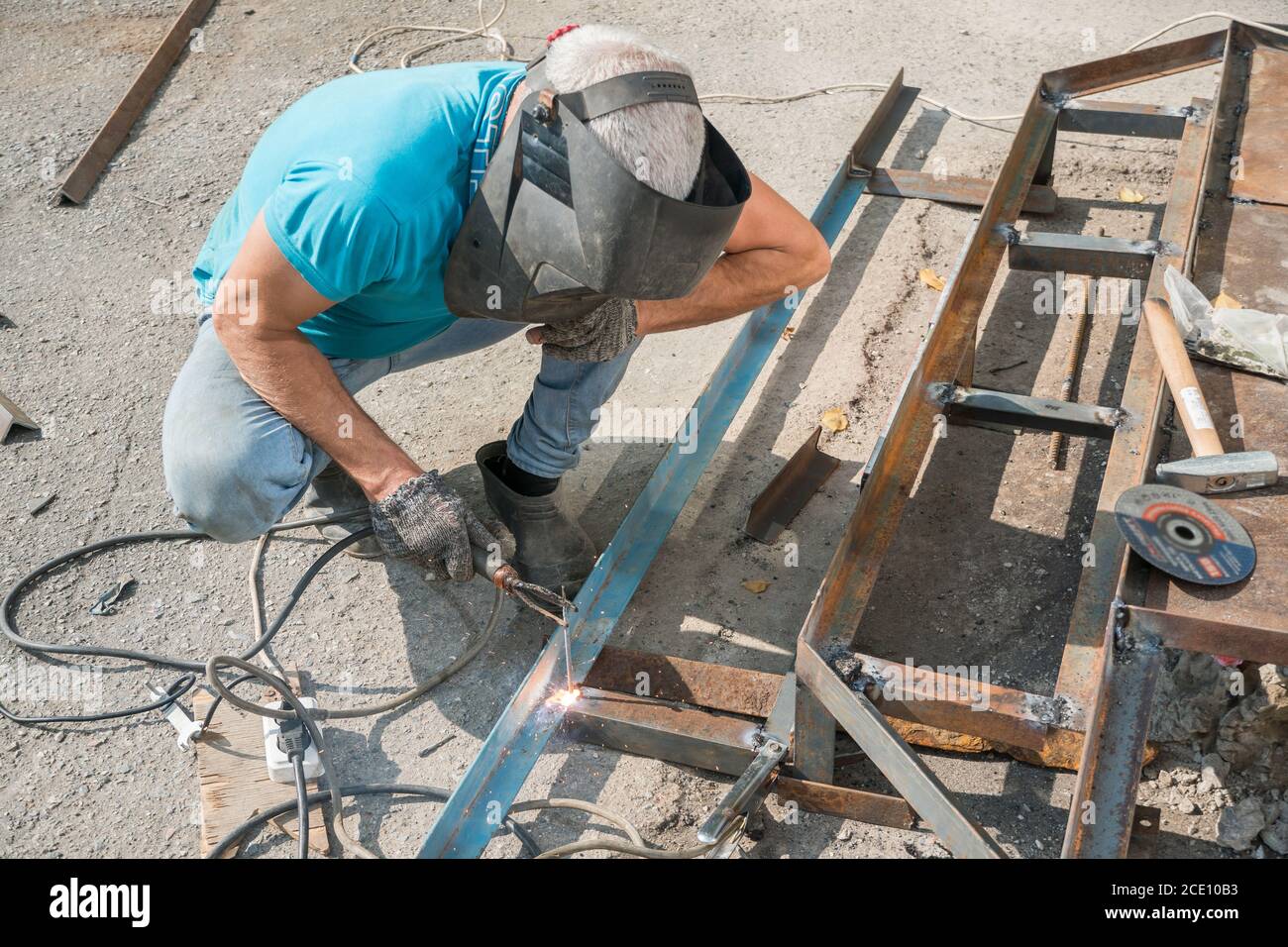 Welder welds metal structure. Construction worker at work. A working ...