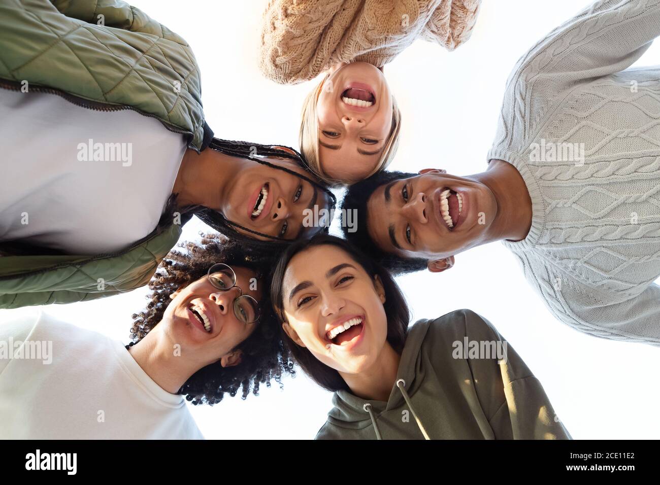 Smiling multiracial friends forming circle of heads Stock Photo - Alamy