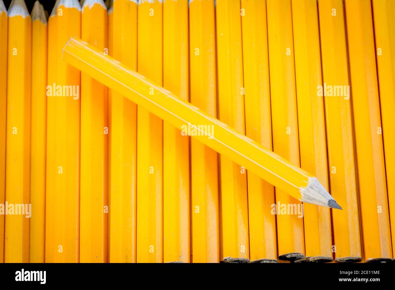 Many little yellow pencils with one sharpened Stock Photo - Alamy