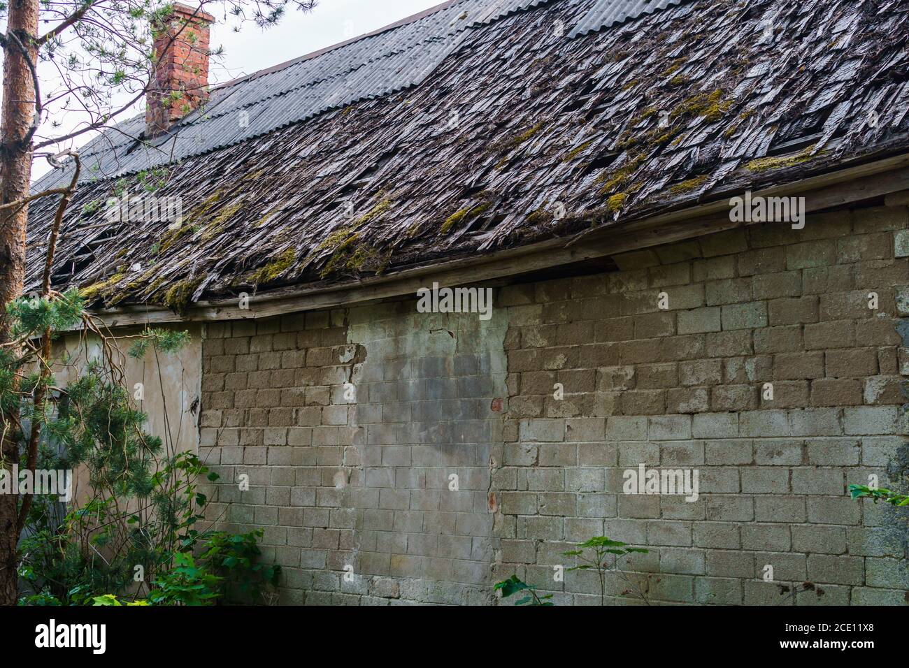 Abandoned, falling apart house in the countryside. Holes in the roof ...