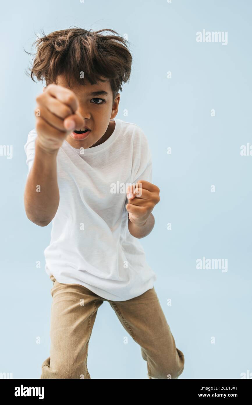 Aggressive asian kid poking camera with poorly closed fists, pretending ...