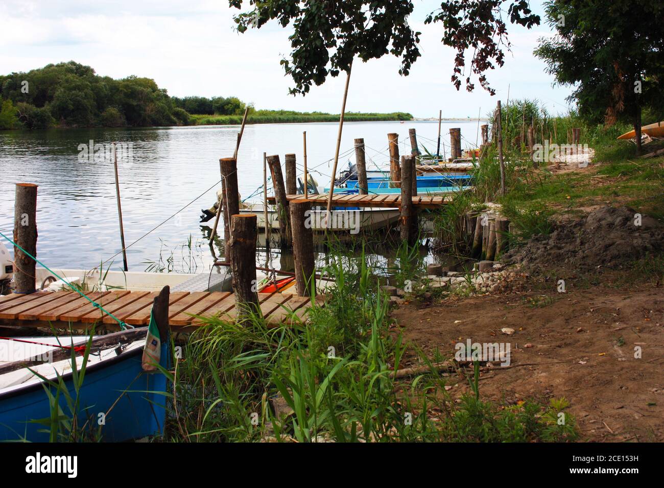rustic craft marina on a swampy river where small boats moor in the ...