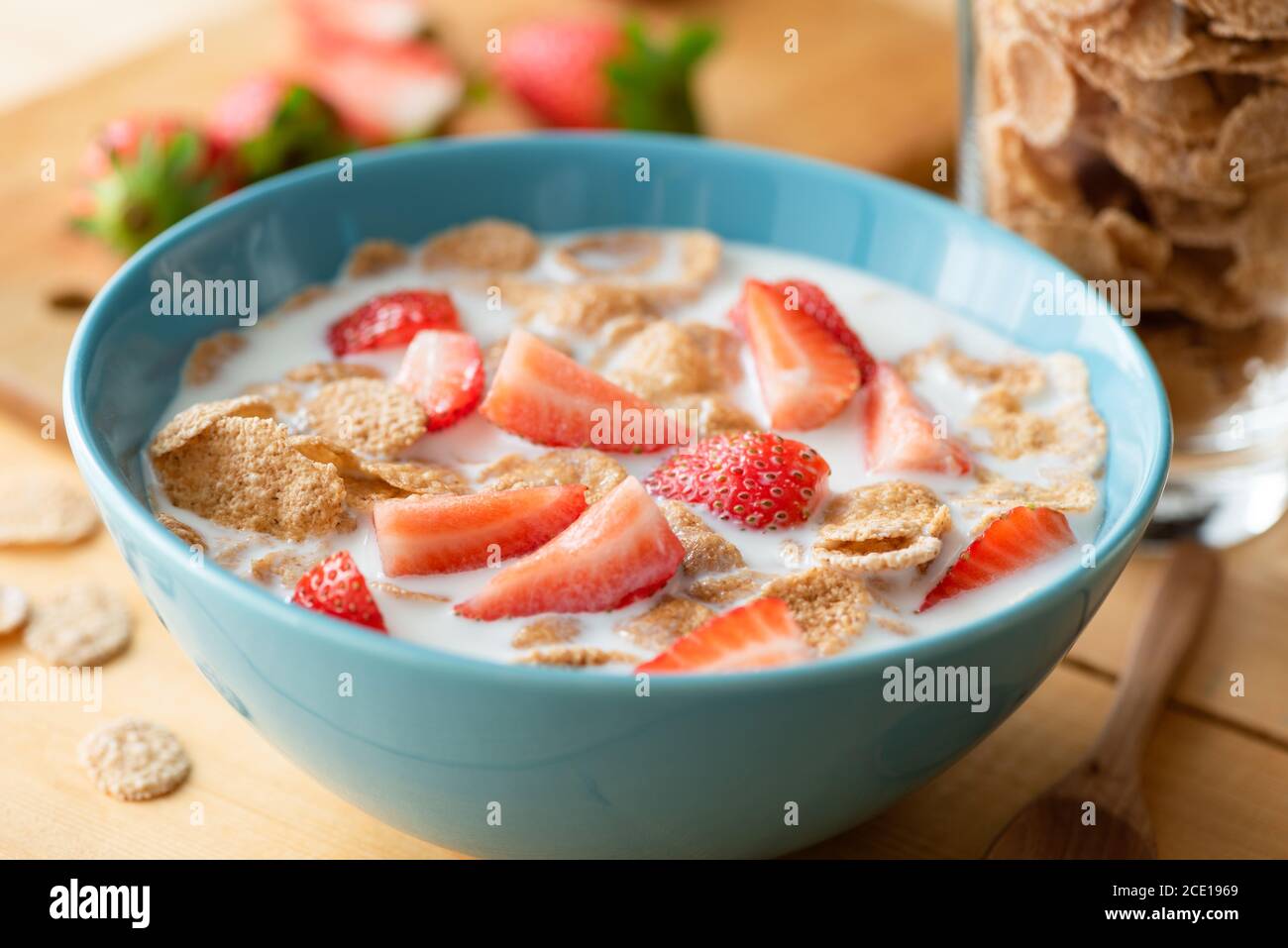 Whole grain flakes with milk and strawberries. Breakfast cereals with ...