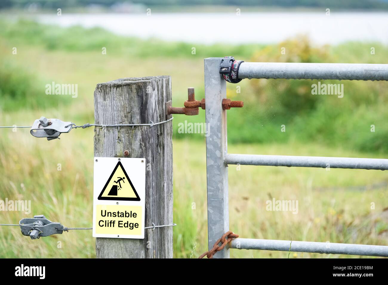 Unstable cliff edge danger gate sign at beach Stock Photo - Alamy