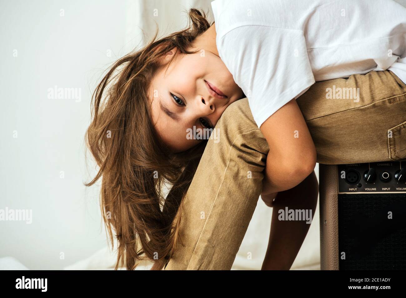 Portrait girl sitting hugging knees hi-res stock photography and images ...