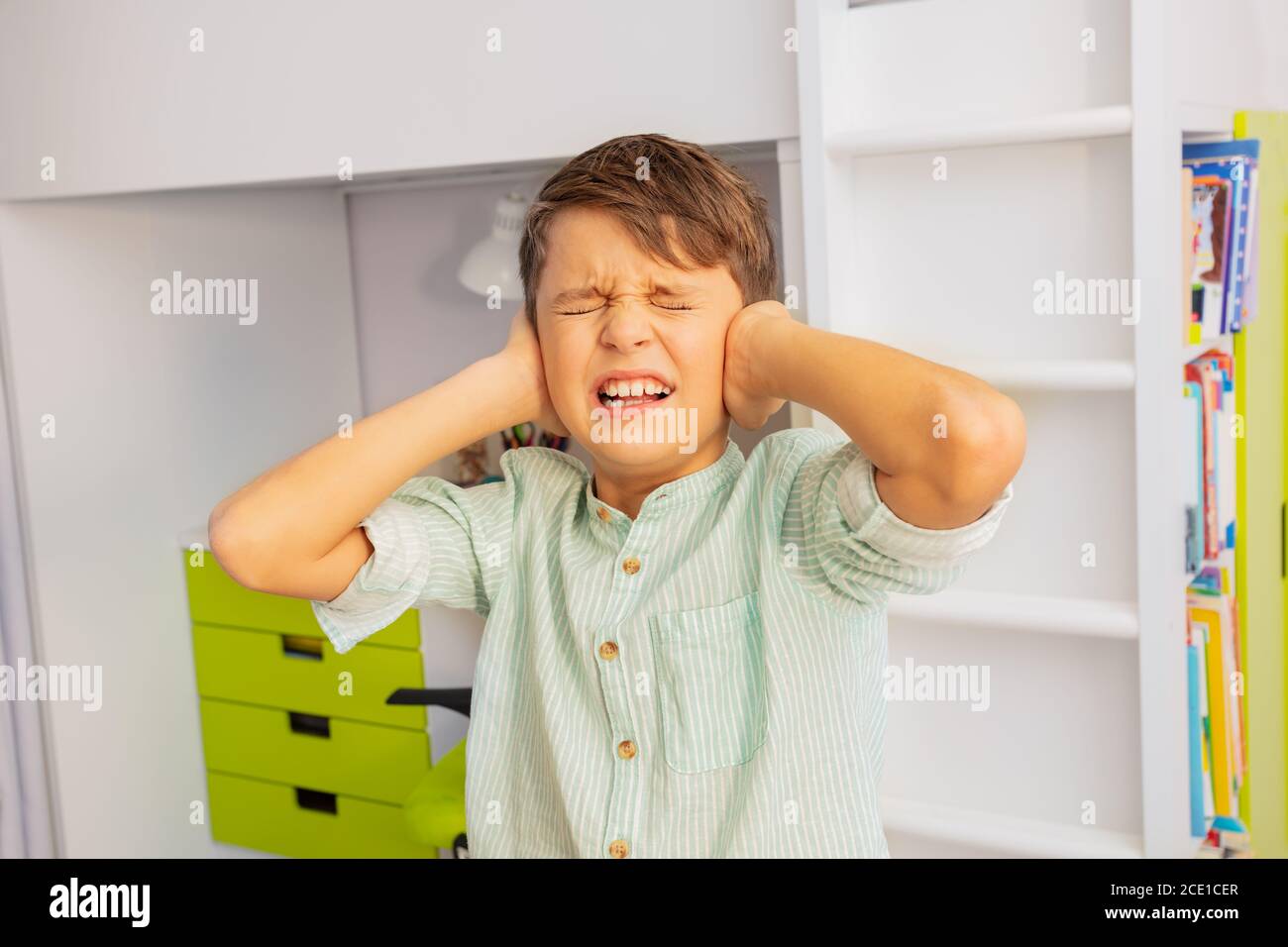 Close portrait of little autistic boy with strong negative face ...
