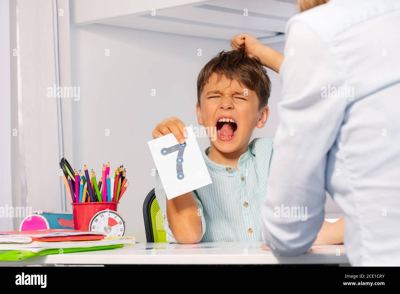 Boy with autism tear hairs and scream expressing negative emotions ...