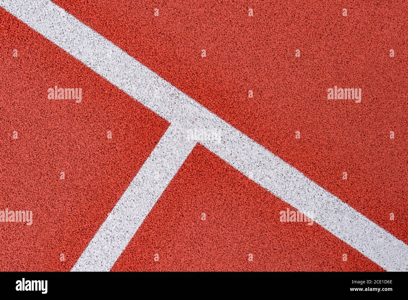 Close up on a white line in artificial red turf, on a street basketball ...