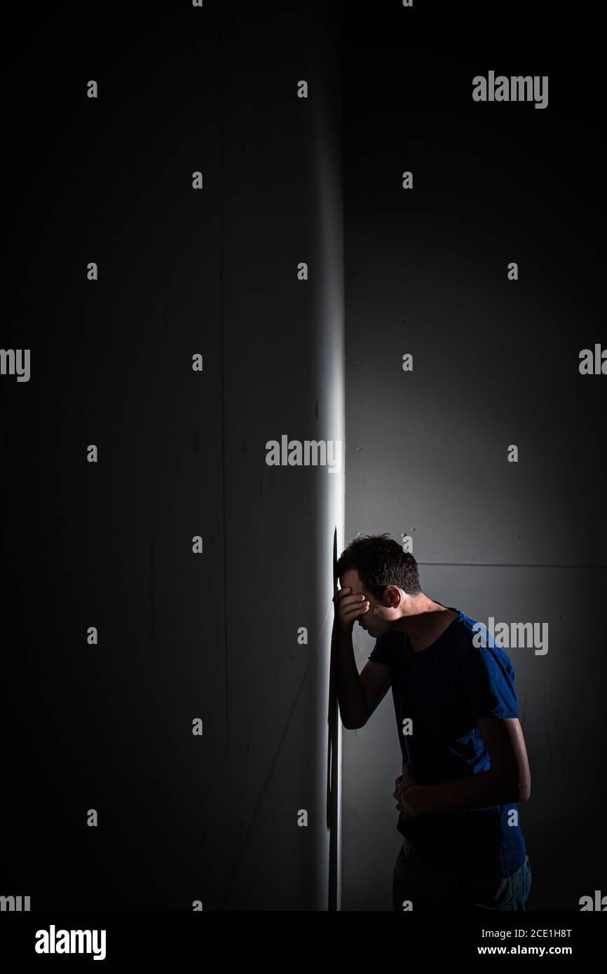 Young man suffering from severe belly pain, being cornered by the ...