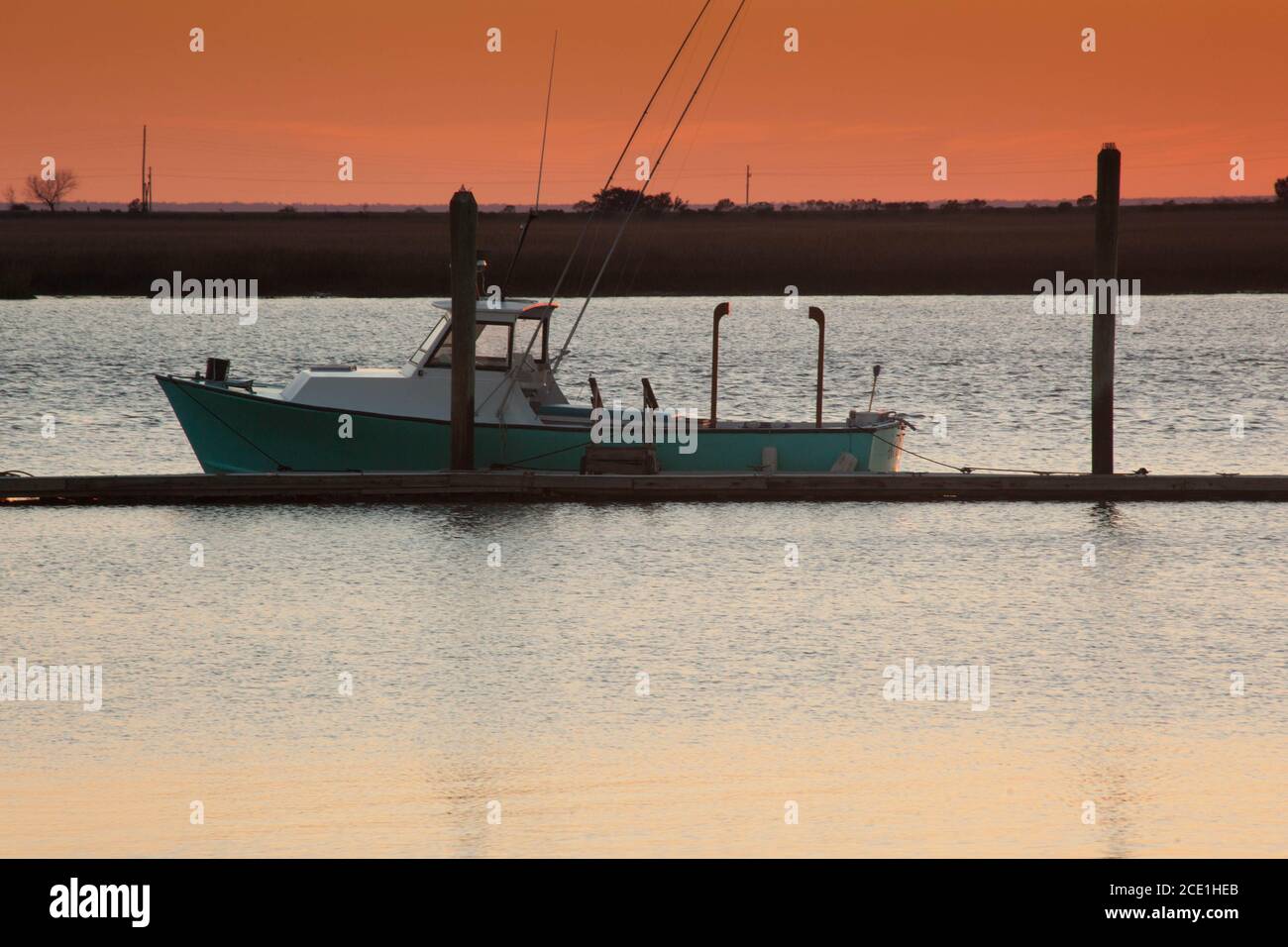 Boat at a dock Sunset Stock Photo - Alamy
