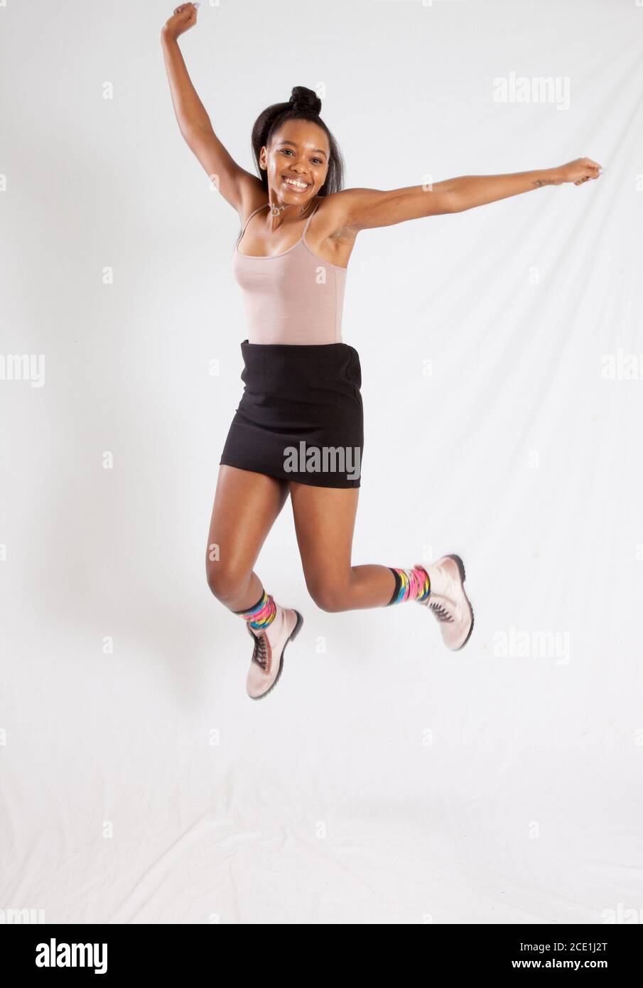 Beautiful woman jumping with joy Stock Photo - Alamy