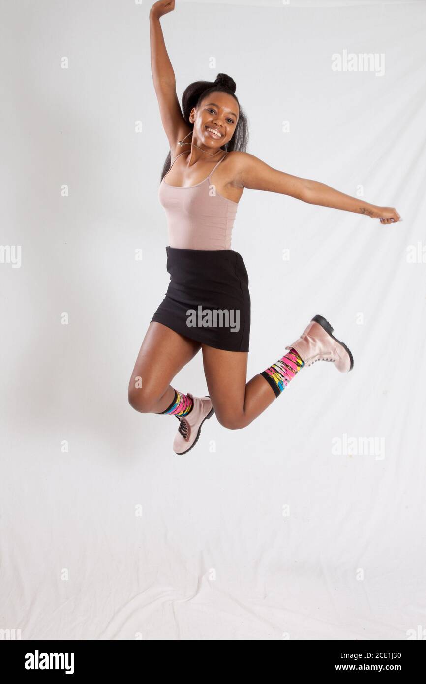 Beautiful woman jumping with joy Stock Photo - Alamy