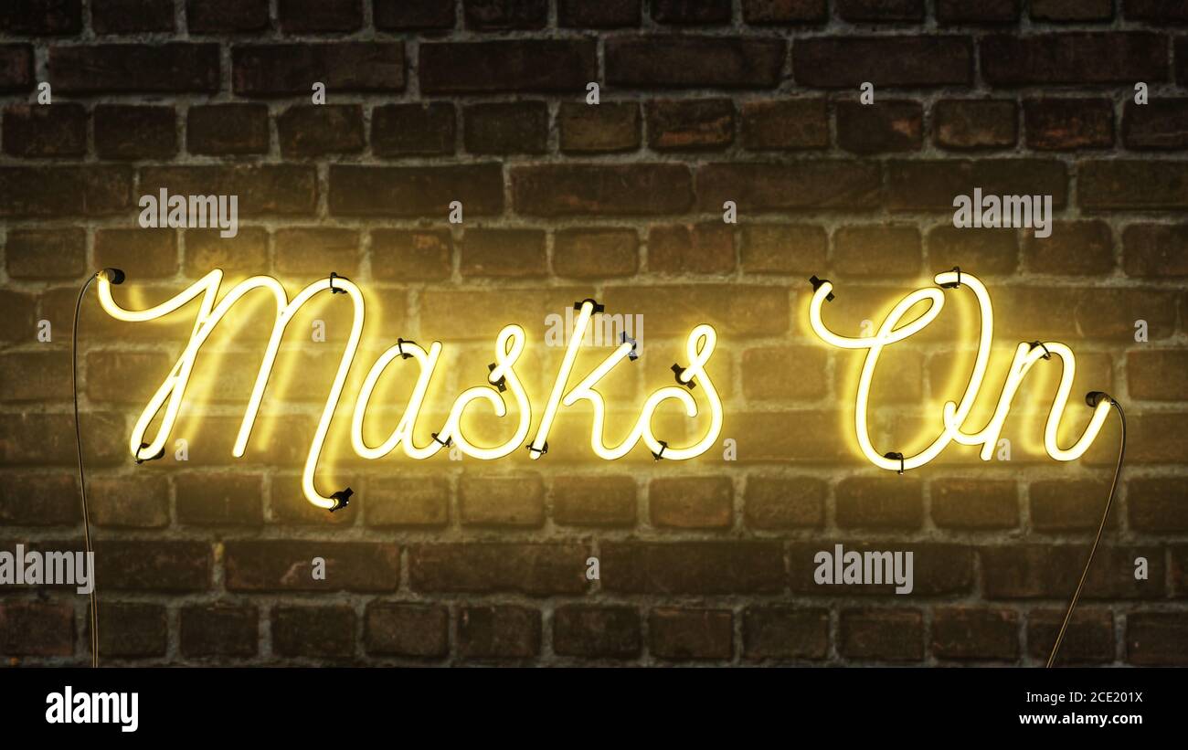 Neon sign on a brick wall background saying Masks on warning people to ...