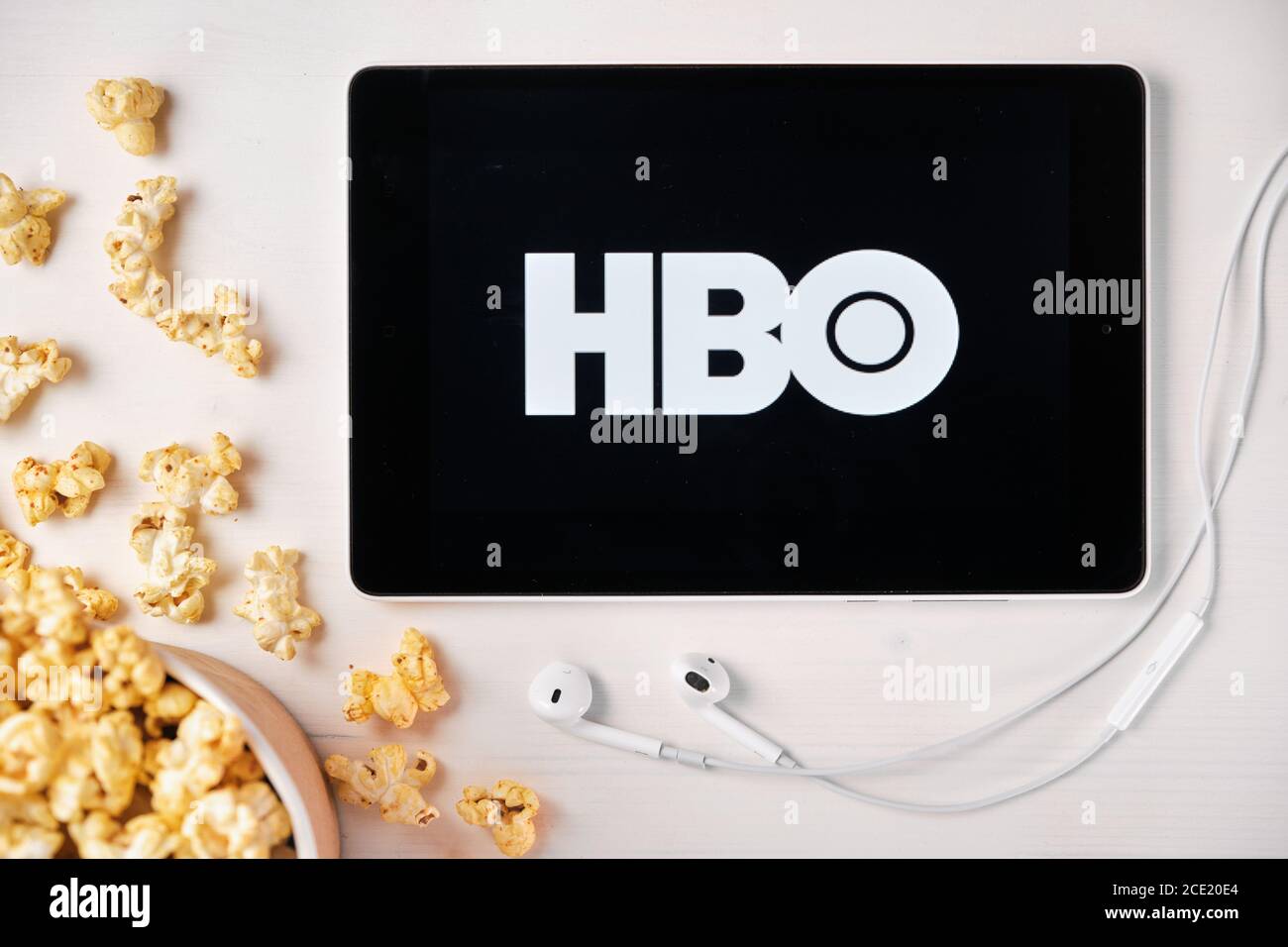 HBO logo on the screen of the tablet laying on the white table and ...