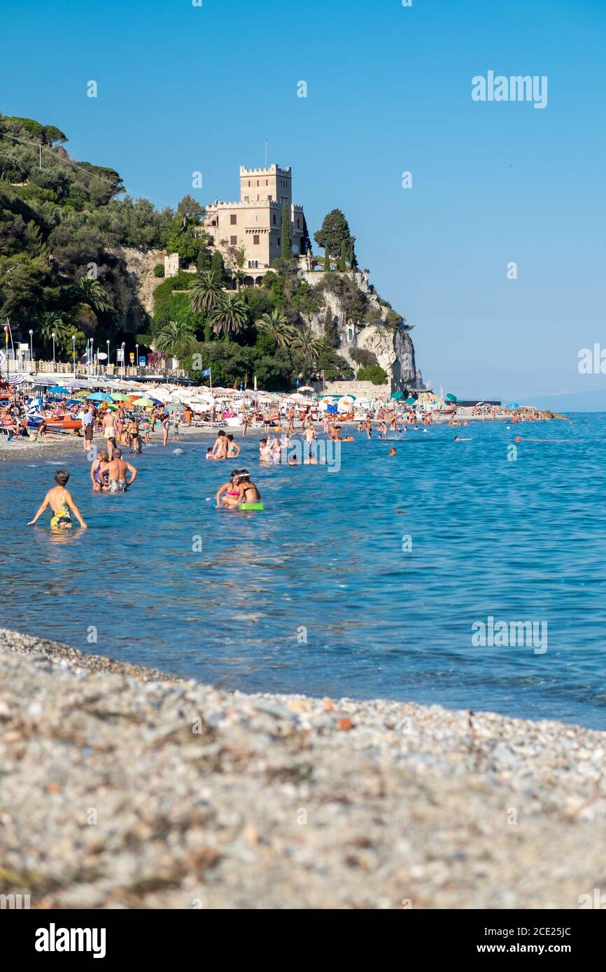 Beach and people swimming in the sea at Finale Ligure, Liguria, Italy ...