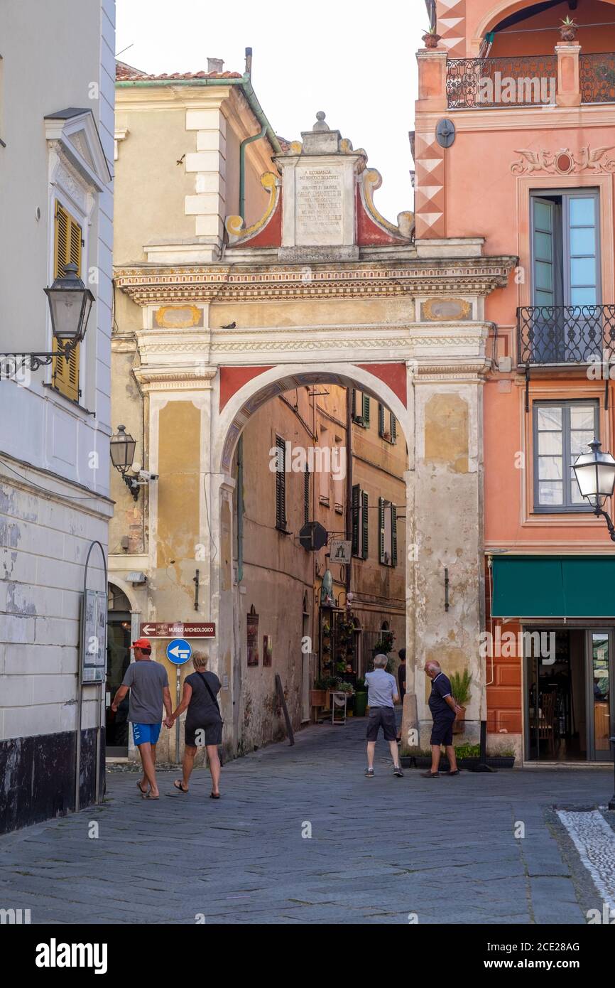 People and old buildings in the old town of Finalborgo, Finale Ligure ...