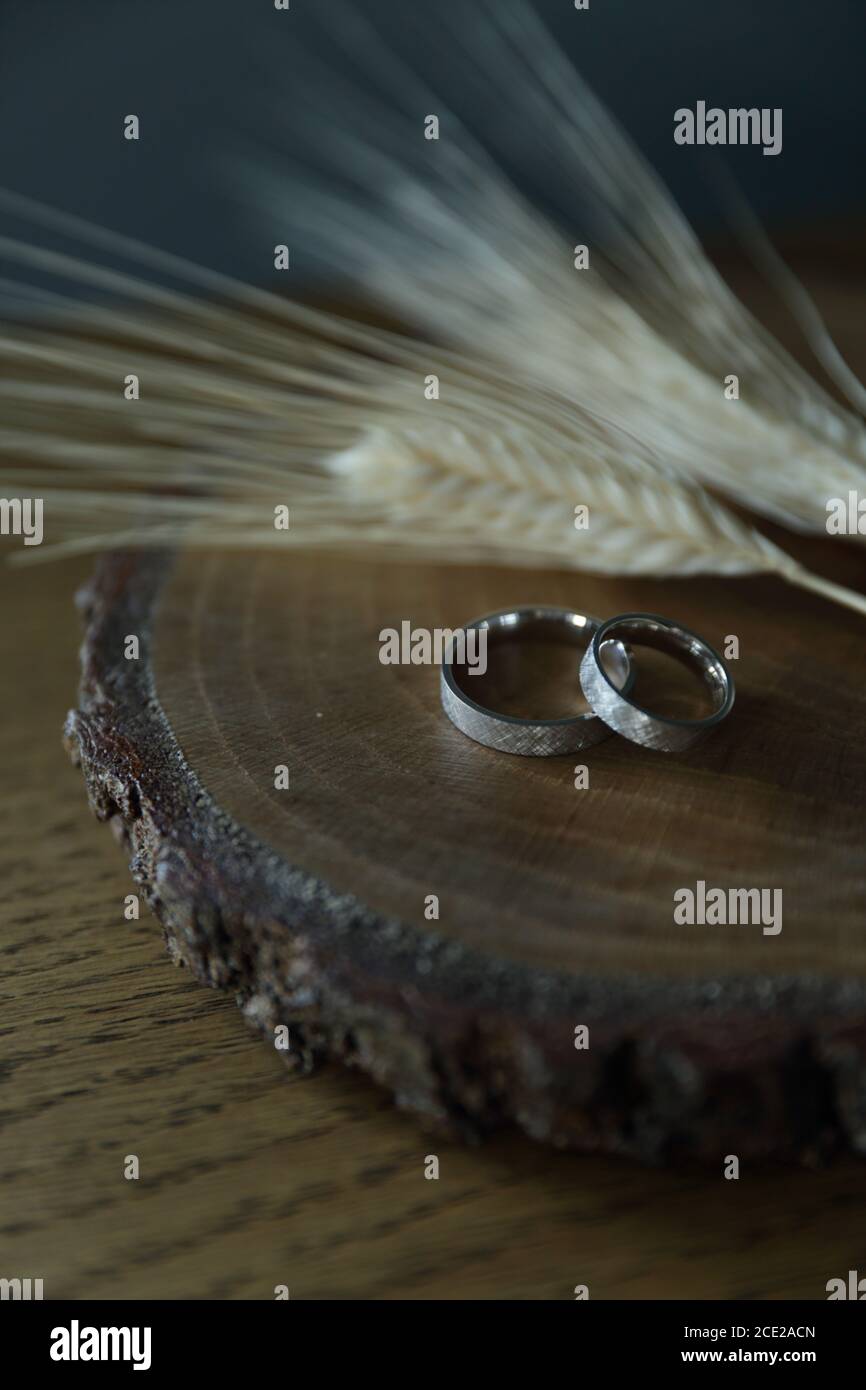Wedding Rings on wooden board with minimal background Stock Photo - Alamy
