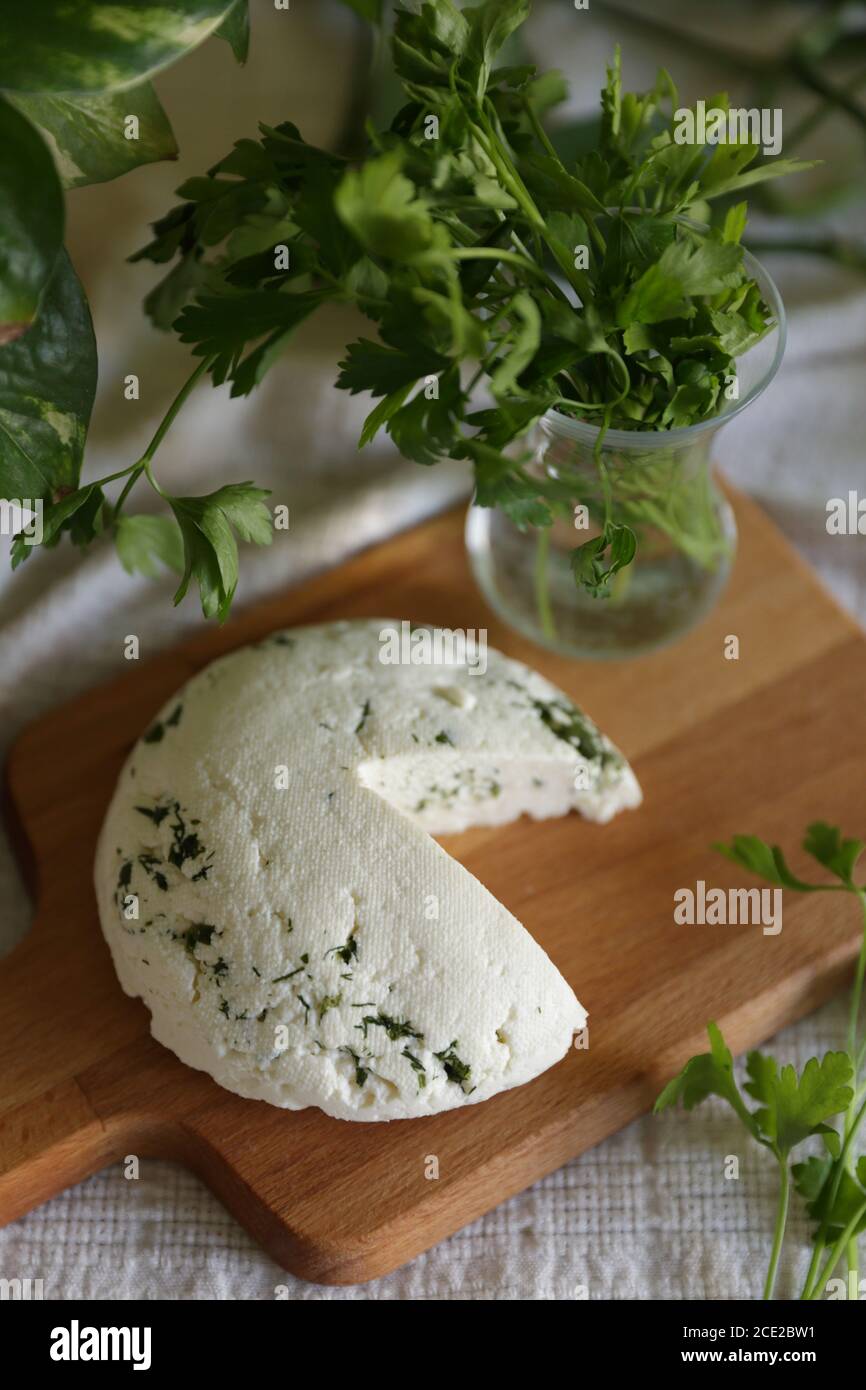 Homemade cheese from milk with vegatables on board Stock Photo - Alamy