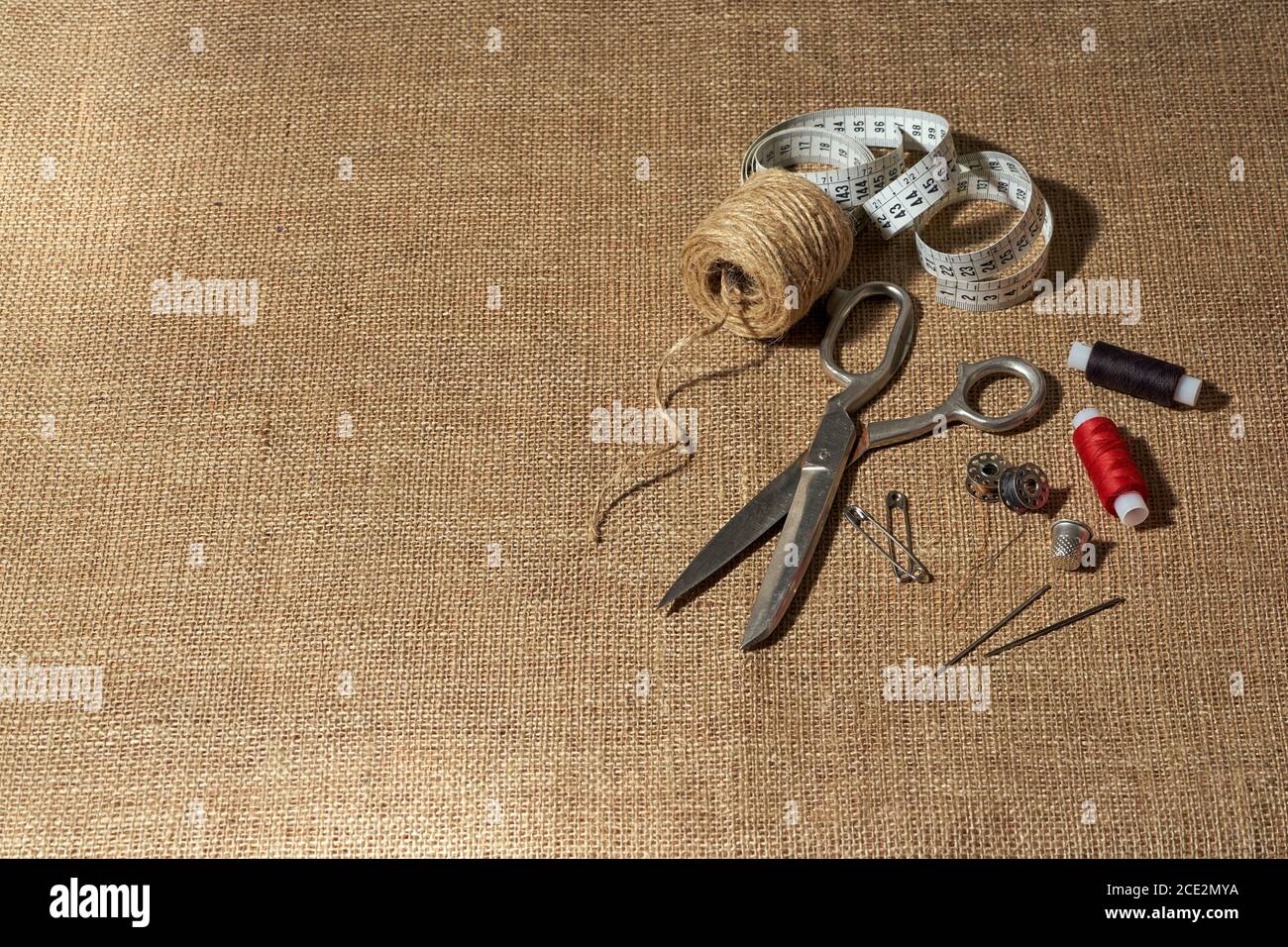 Handmade tools: thimble, thread, needle, pin, tape measure, scissors on ...