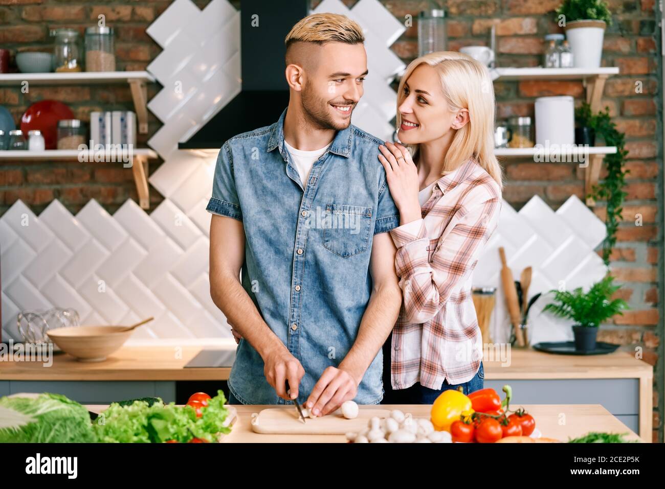Young couple cooking together home hi-res stock photography and images ...
